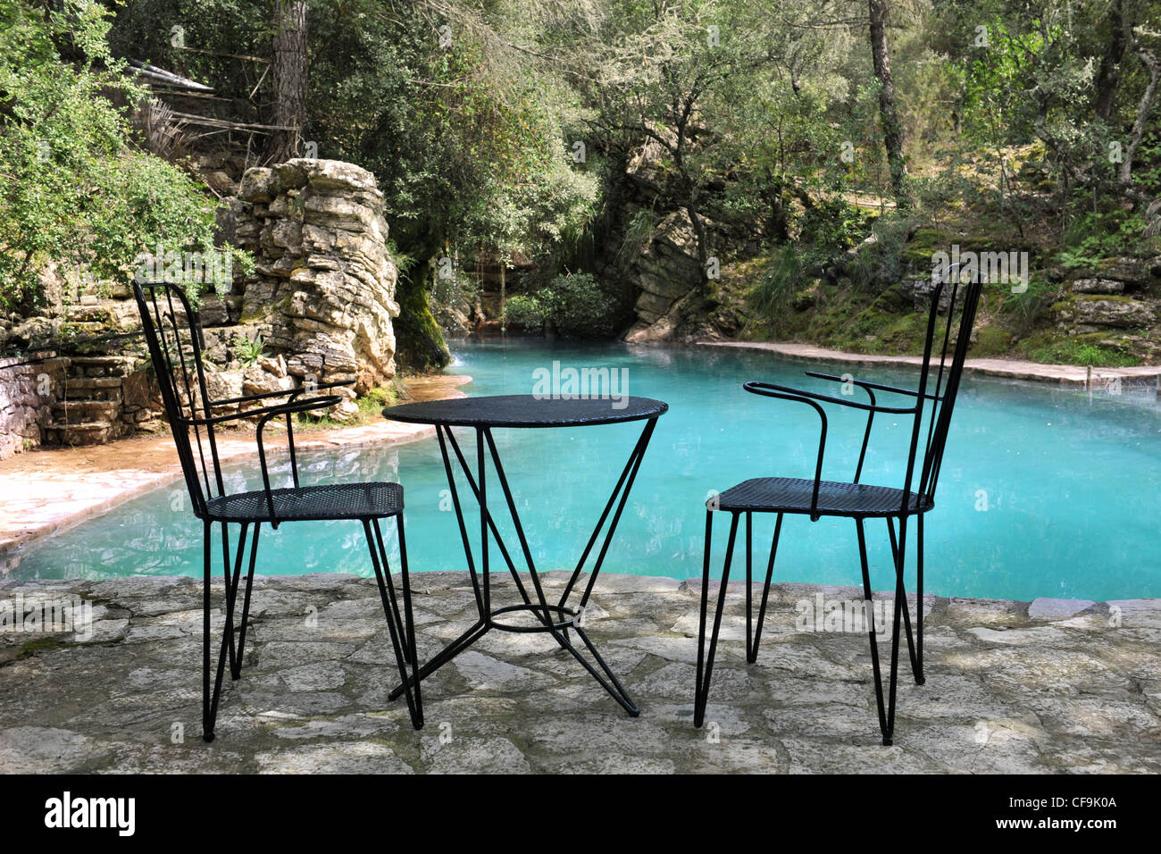 chairs and table on terrace near a natural swimming pool Stock Photo ...