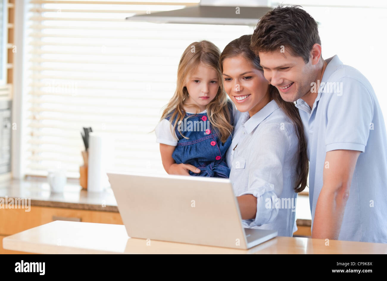 Family using a laptop Stock Photo - Alamy