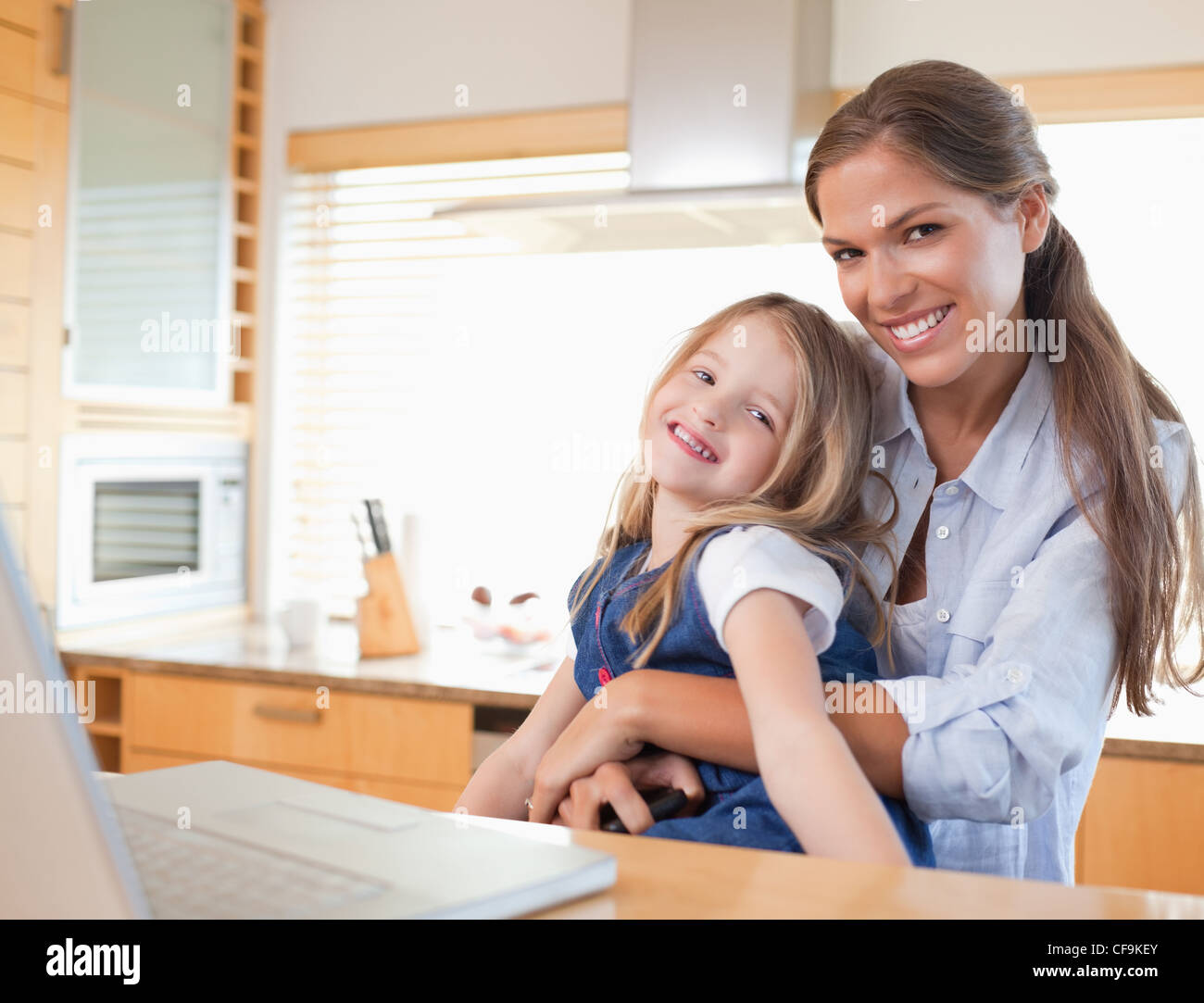 Happy mother and her daughter using a laptop Stock Photo - Alamy