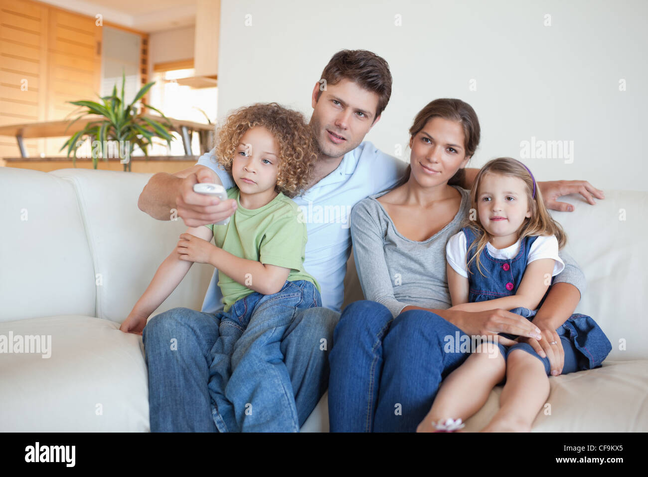 Family watching TV together Stock Photo - Alamy