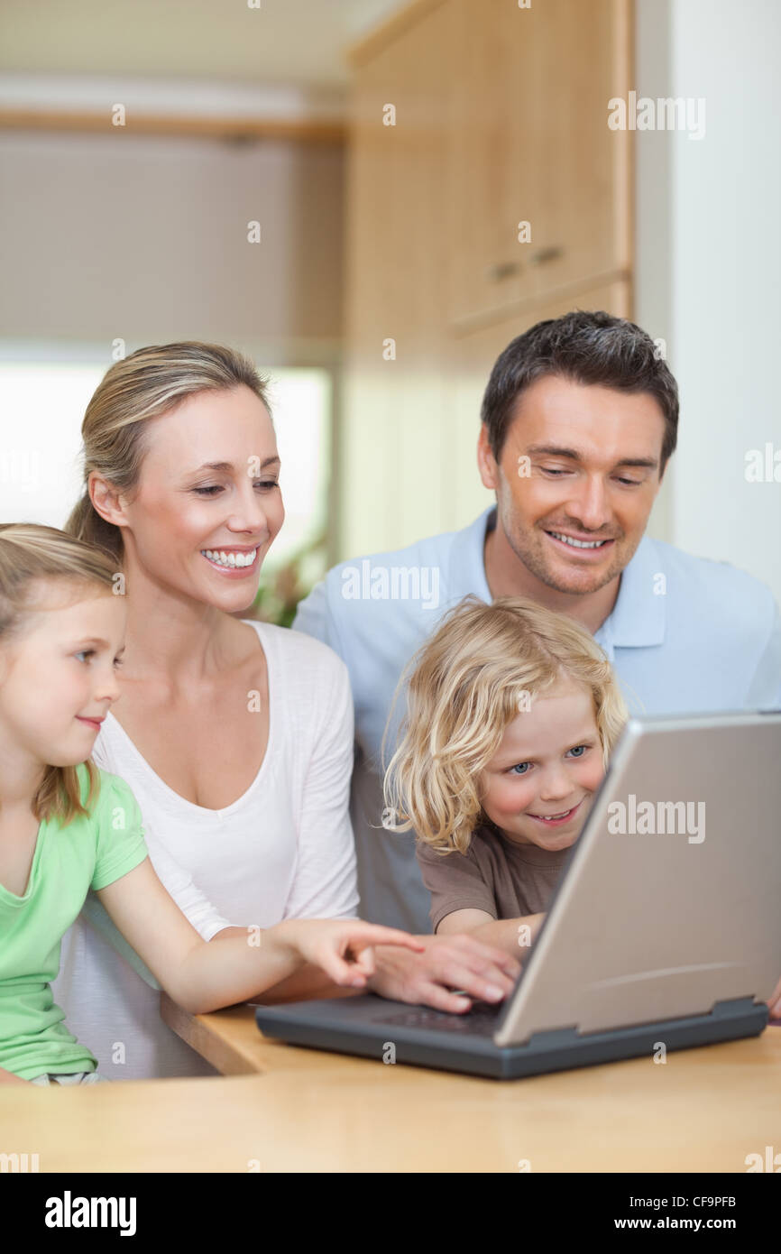 Family using laptop in the kitchen Stock Photo - Alamy
