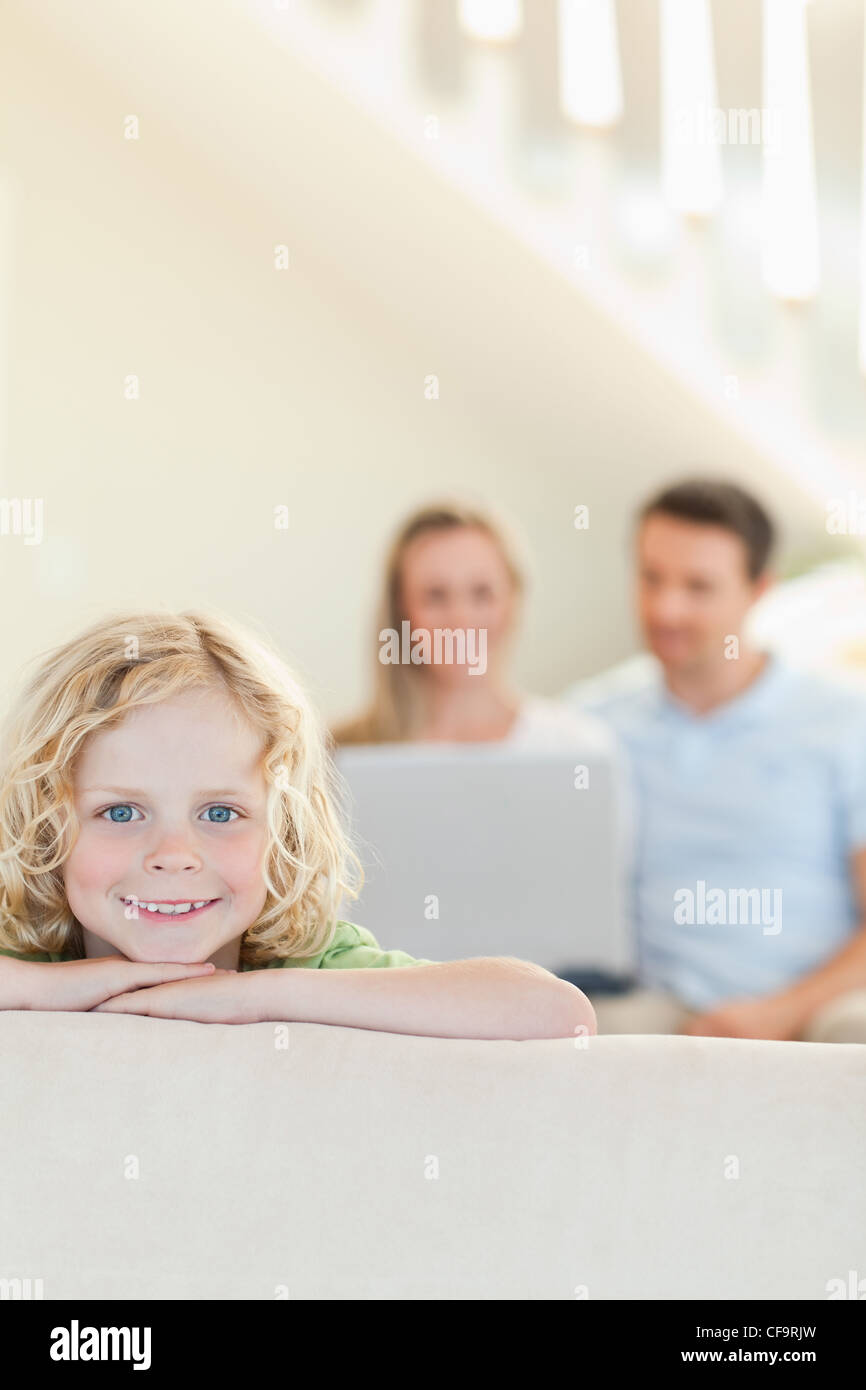 Happy boy with parents in the background Stock Photo - Alamy