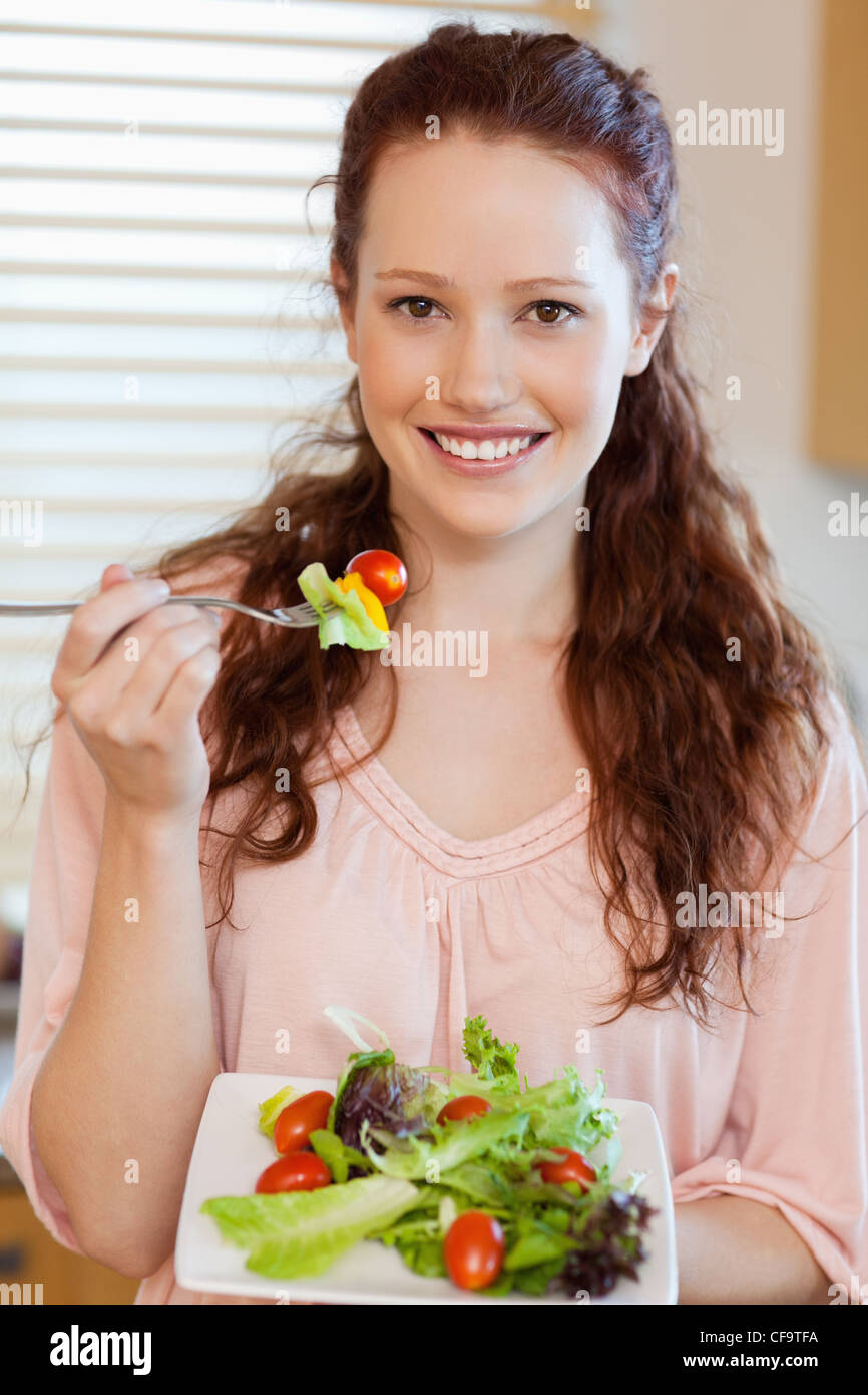 Girl eating salad Stock Photo - Alamy