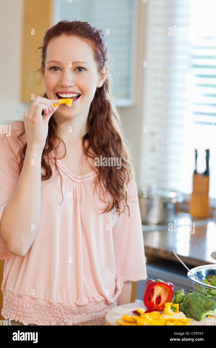 Woman eating bell pepper Stock Photo - Alamy
