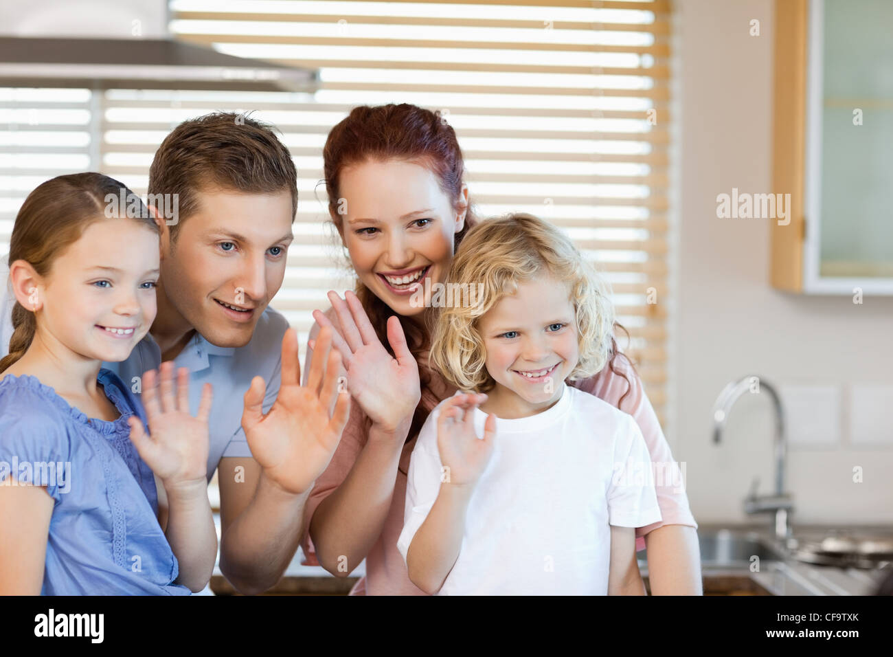 Family waving with their hands Stock Photo - Alamy