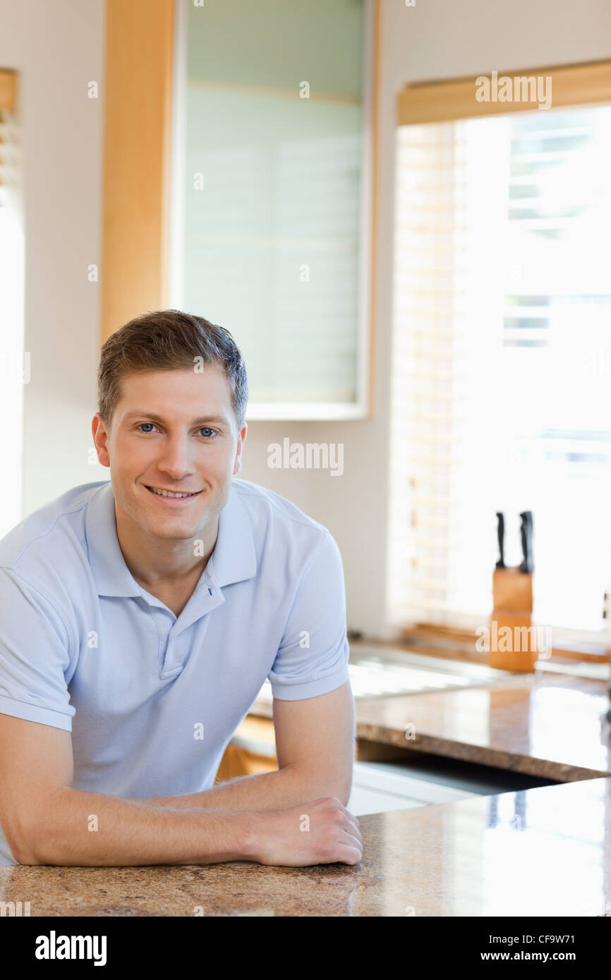 Man leaning against the kitchen counter Stock Photo - Alamy