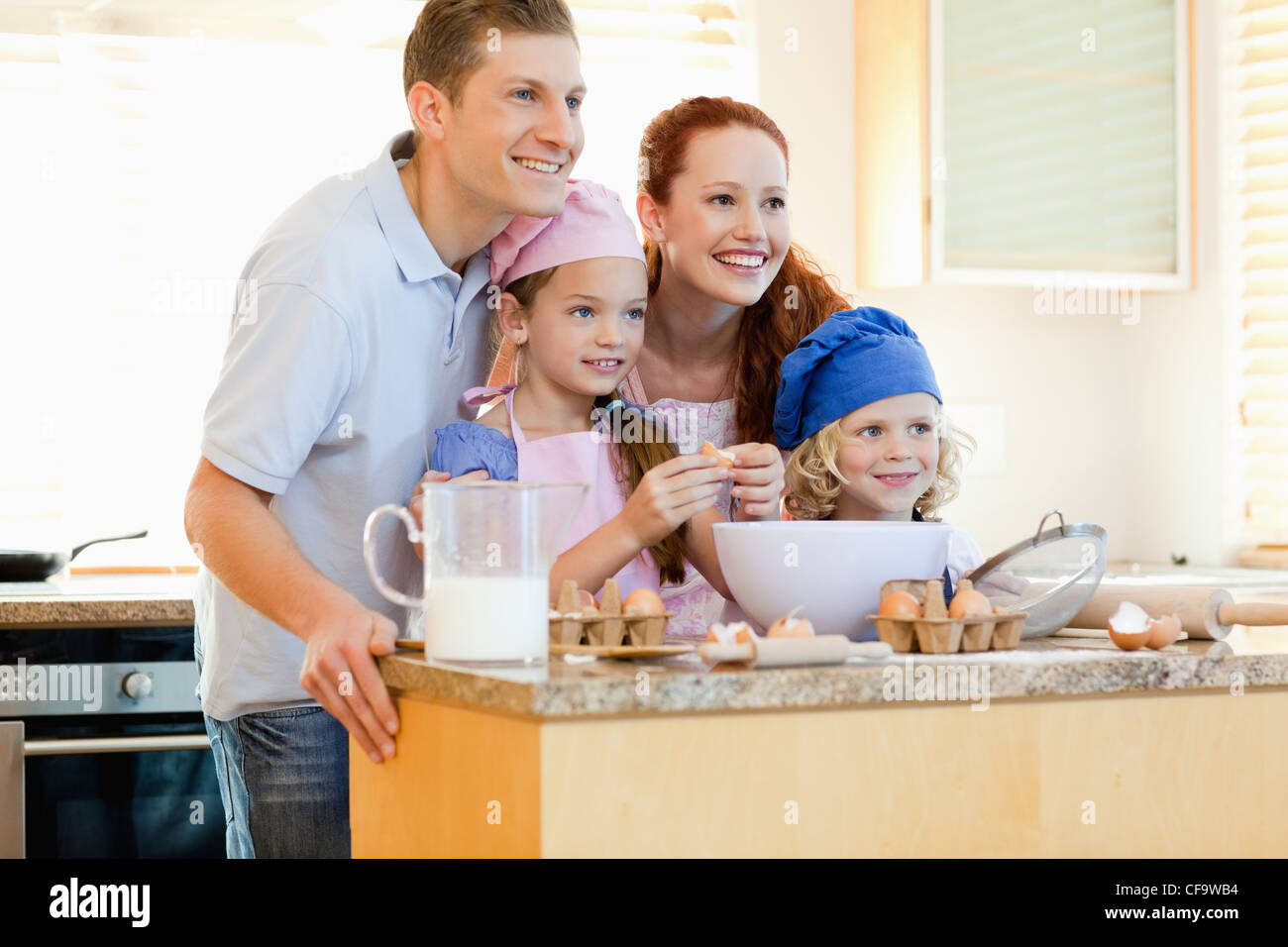 Family in the kitchen with baking ingredients Stock Photo - Alamy