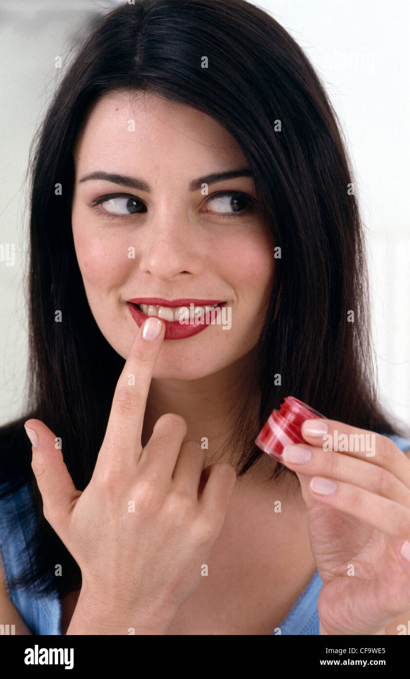 Step by Step Make Up Female brunette hair, applying lip colour the tip ...