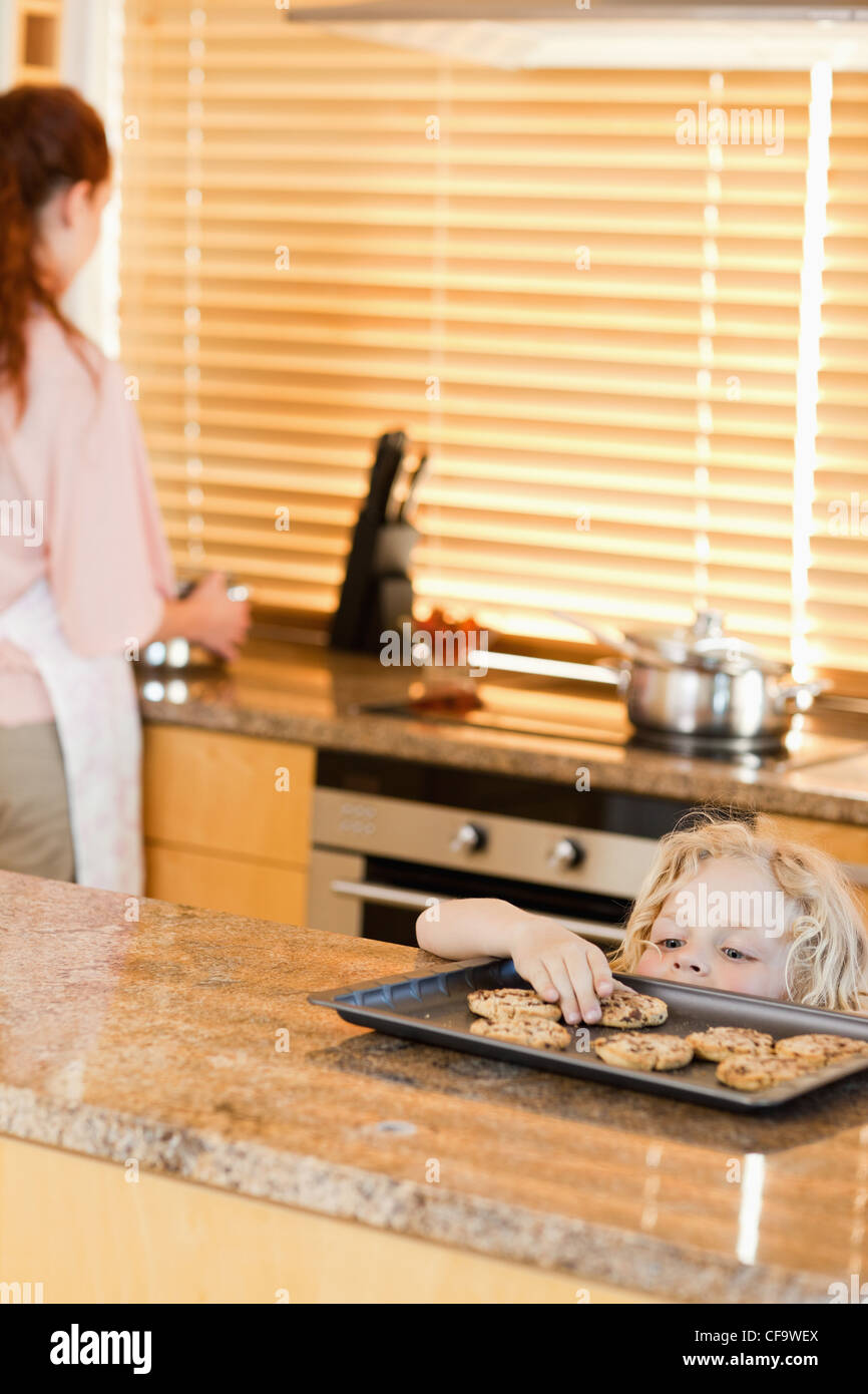 Sneaky boy stealing cookies Stock Photo - Alamy