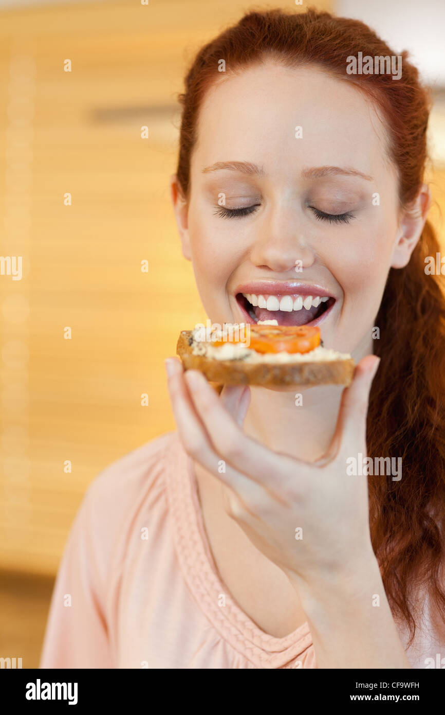 Woman eating a slice of bread Stock Photo - Alamy