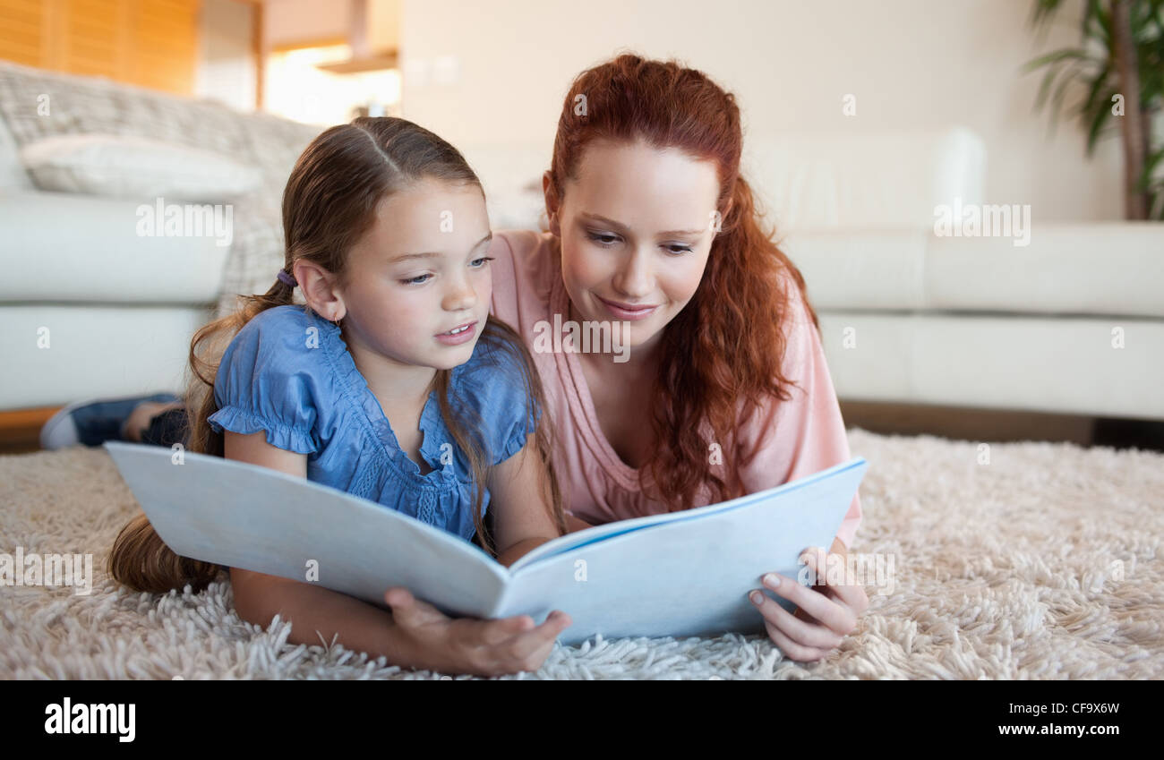 Mother and daughter looking at a magazine Stock Photo - Alamy