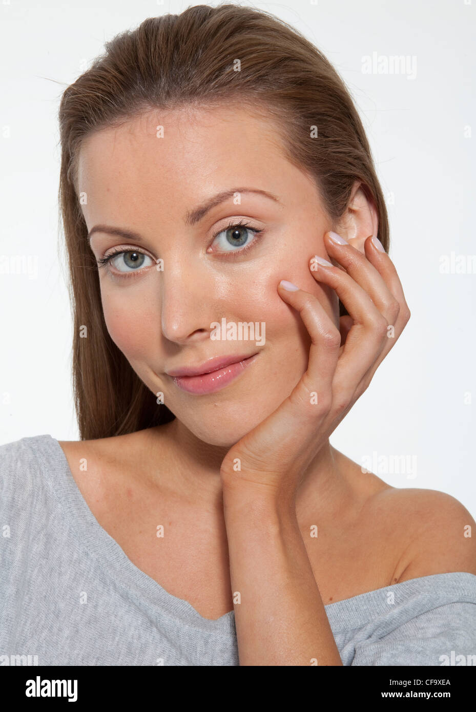 Female fair hair off her face, wearing a grey off the shoulder top ...