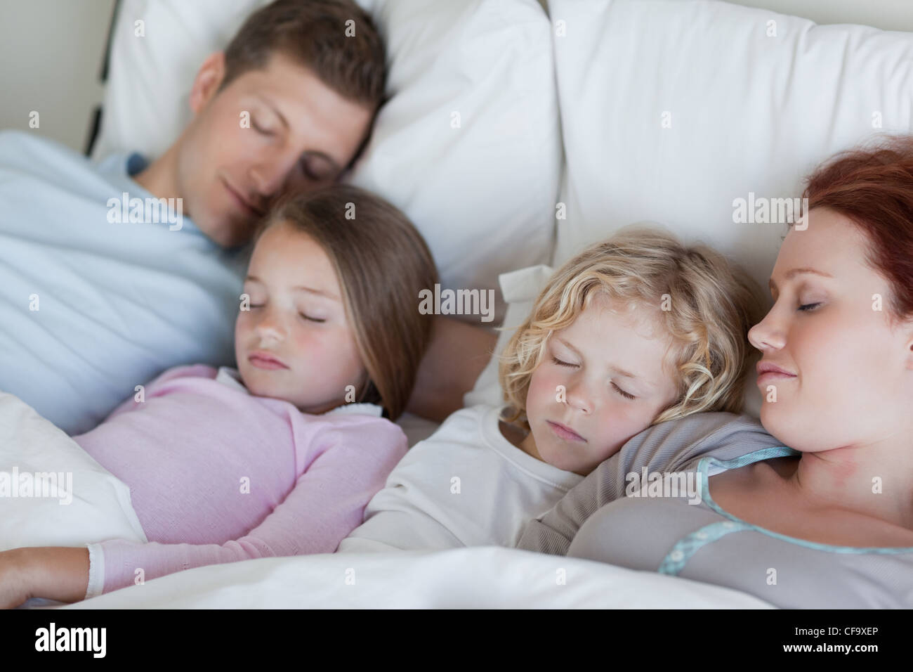 Family snoozing together Stock Photo - Alamy