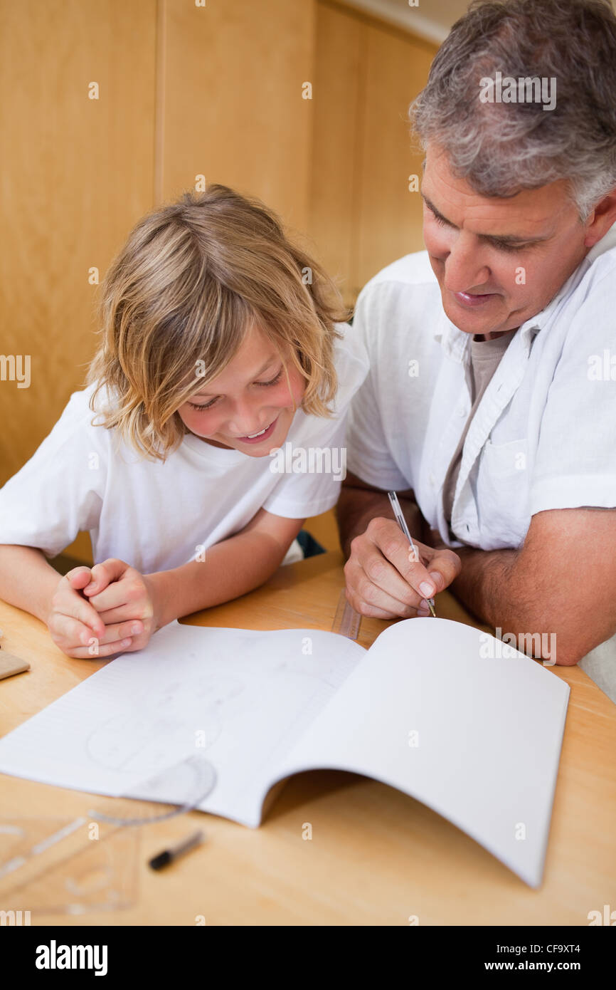 Man explaining homework to son Stock Photo - Alamy