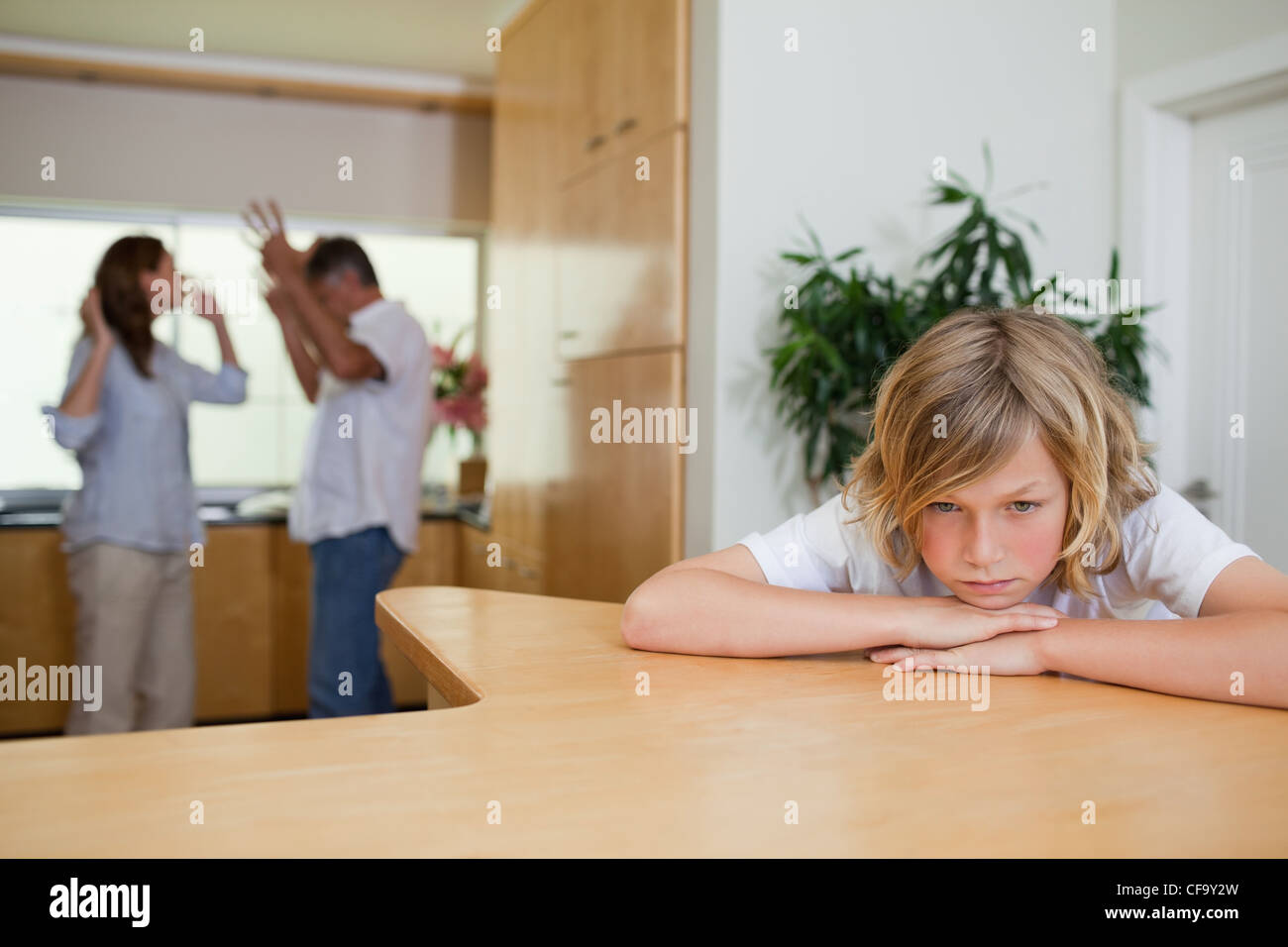 Boy is sad about fighting parents Stock Photo - Alamy