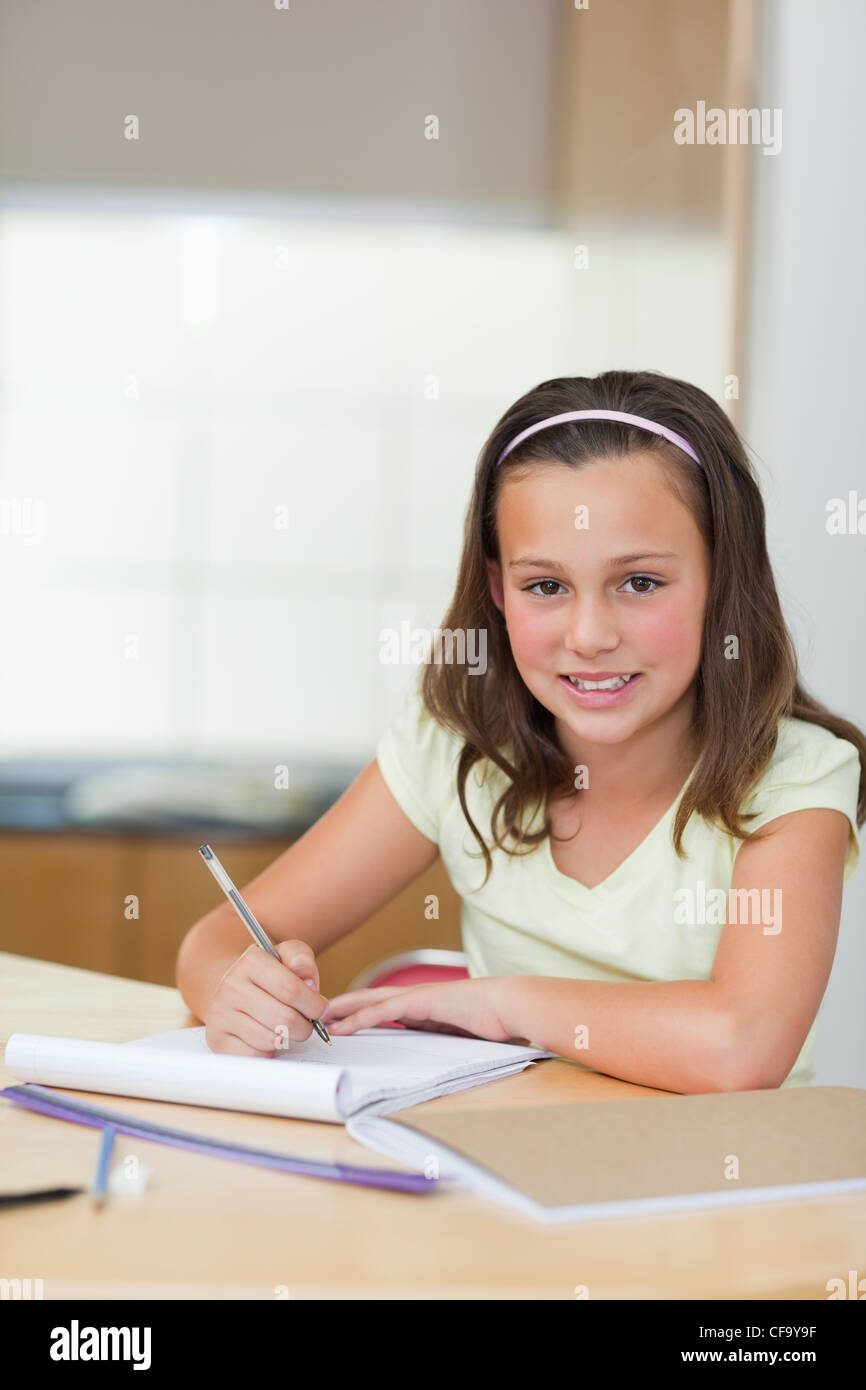 Smiling girl doing homework Stock Photo - Alamy