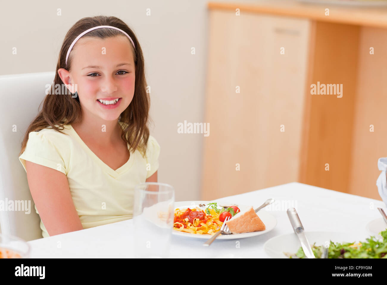 Smiling girl table hi-res stock photography and images - Alamy