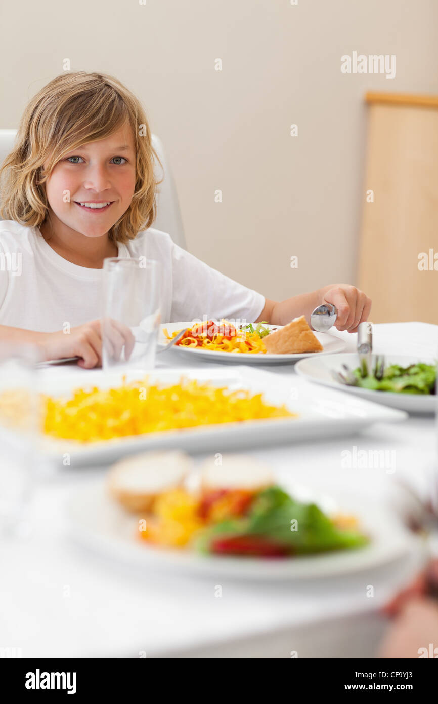 Boy sitting at dinner table Stock Photo - Alamy