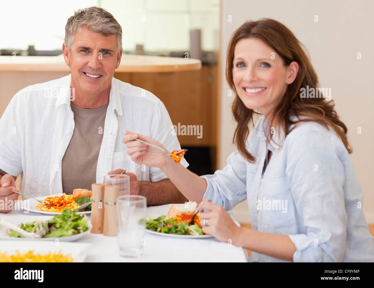 Smiling couple eating dinner Stock Photo - Alamy