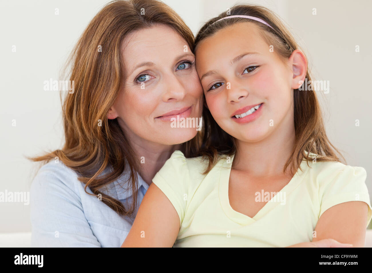 Mother hugging her daughter Stock Photo - Alamy