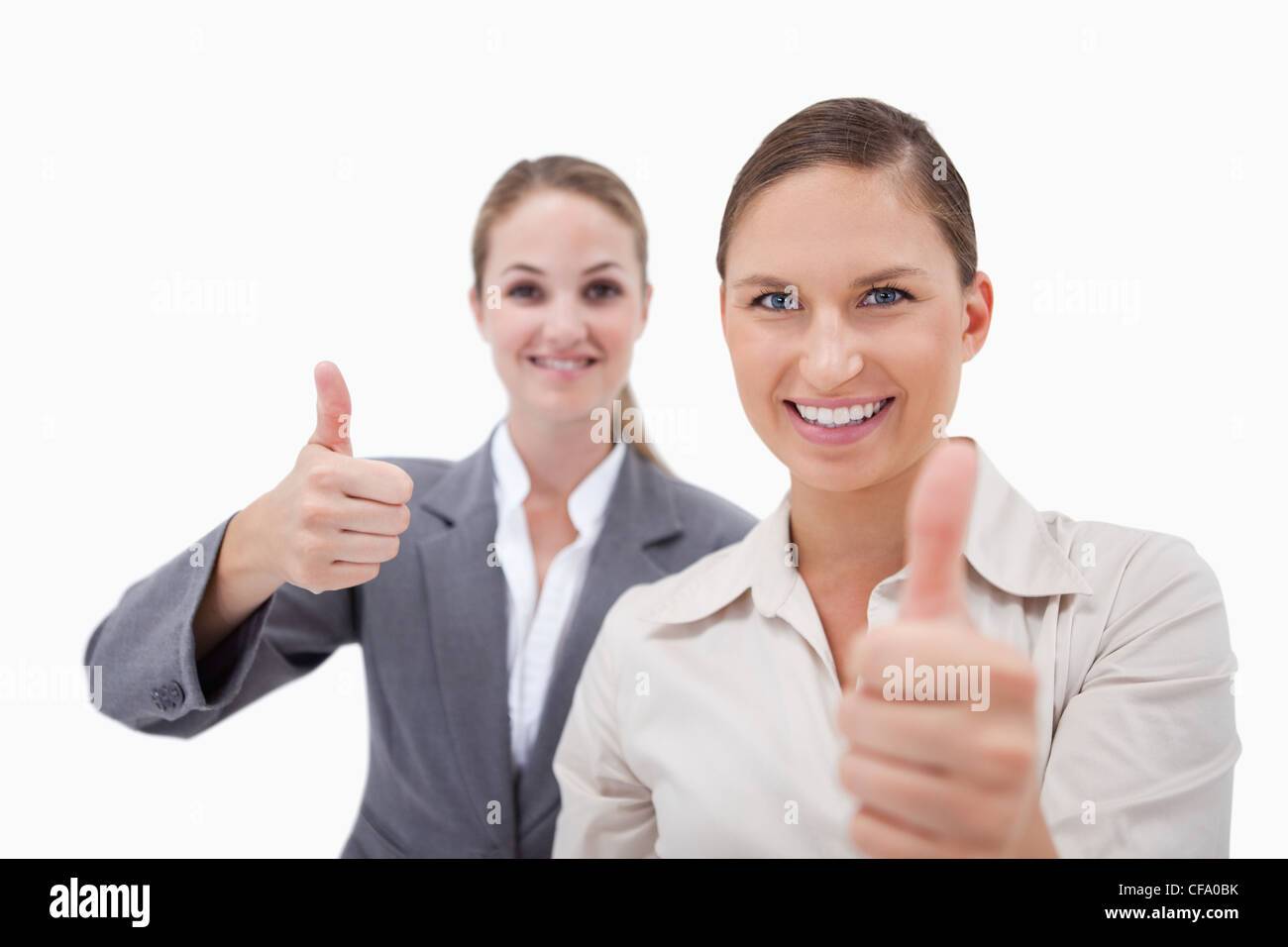 Smiling sales persons posing with the thumb up Stock Photo - Alamy