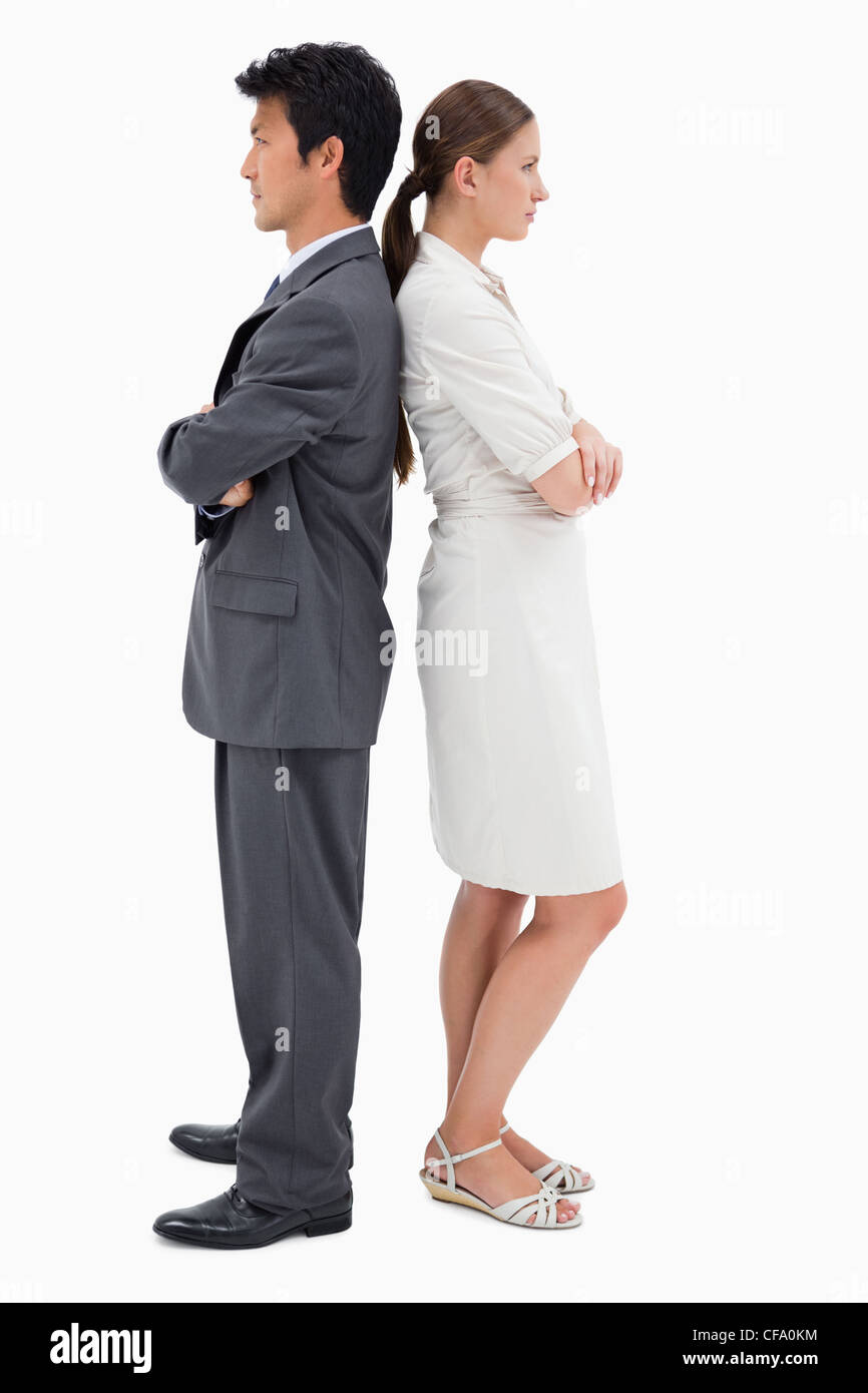 Portrait of serious business people standing back to back Stock Photo ...