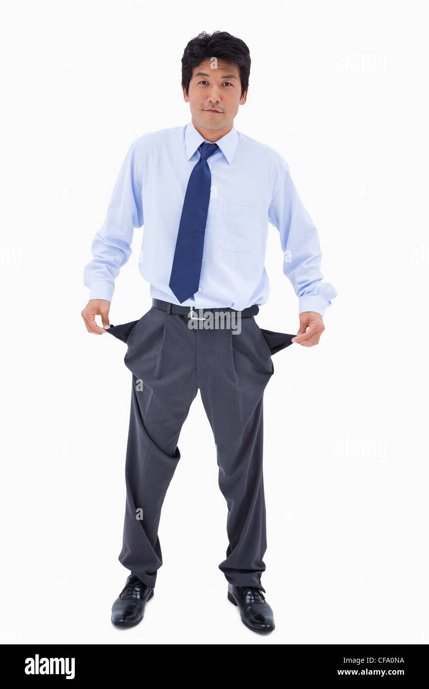 Portrait of a businessman showing his empty pockets Stock Photo - Alamy