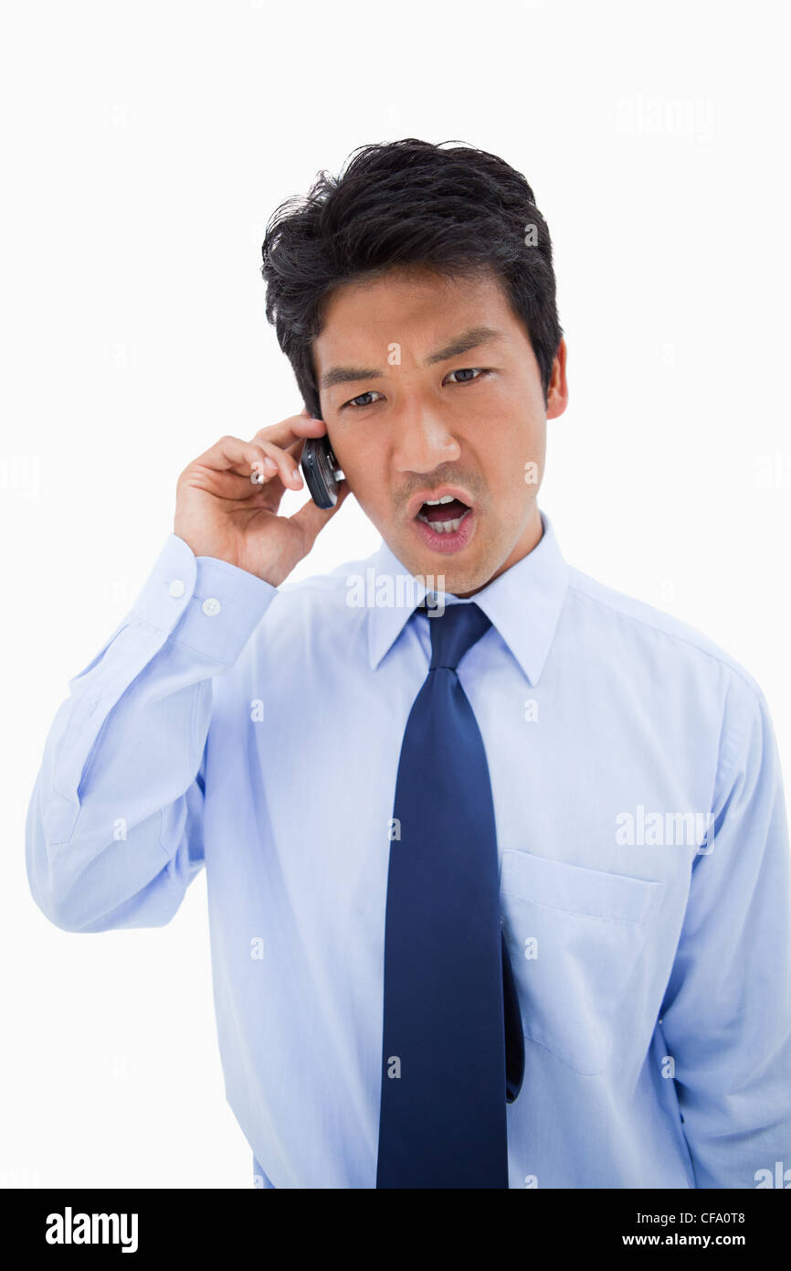 Portrait of an angry businessman making a phone call Stock Photo - Alamy