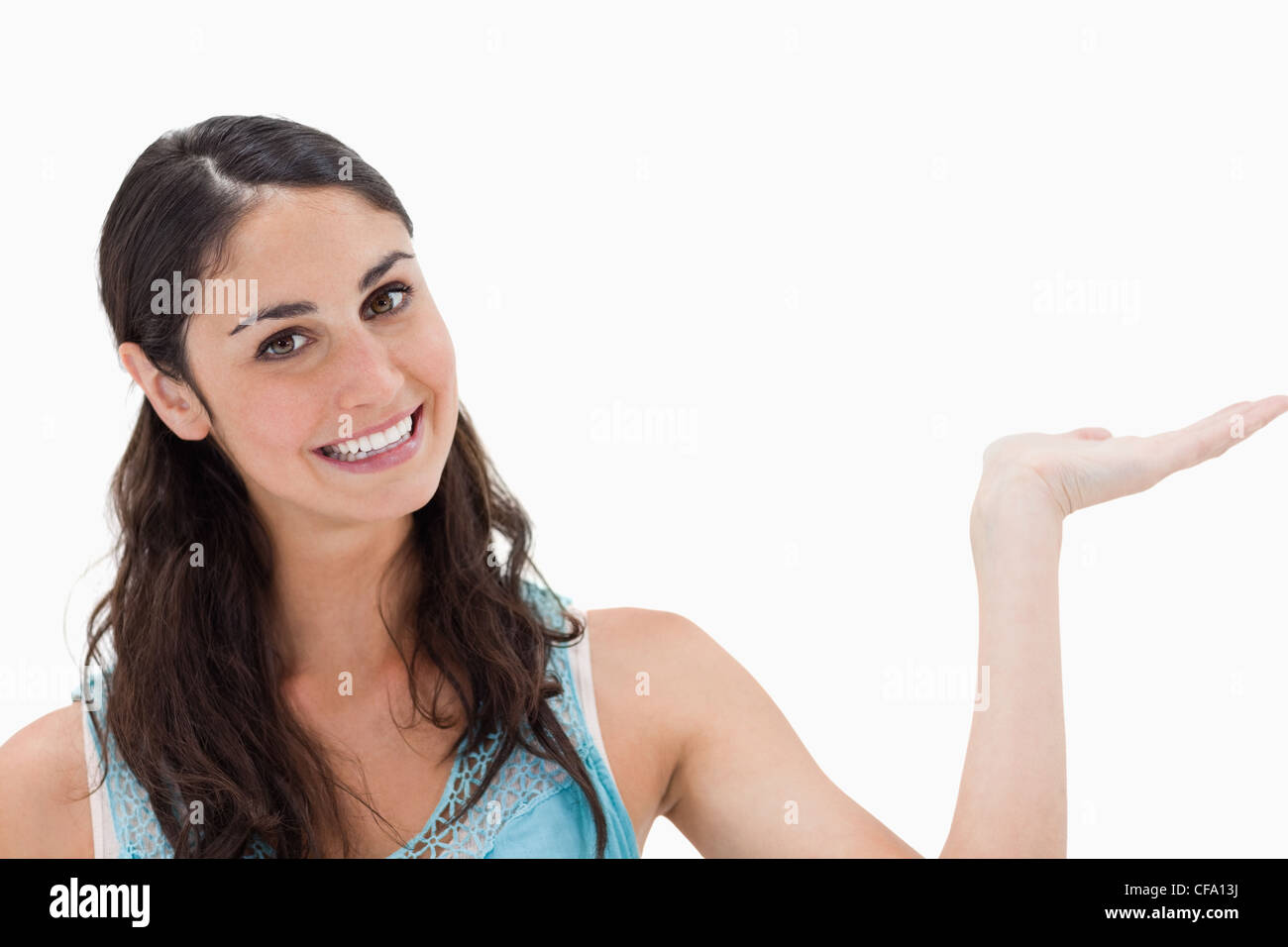 Smiling woman displaying a copy space Stock Photo - Alamy