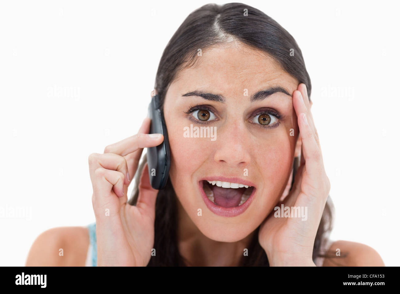 Shocked woman making a phone call Stock Photo - Alamy