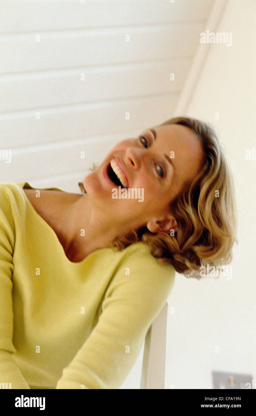 Female with short fair hair, wearing a yellow jumper, smiling, looking ...