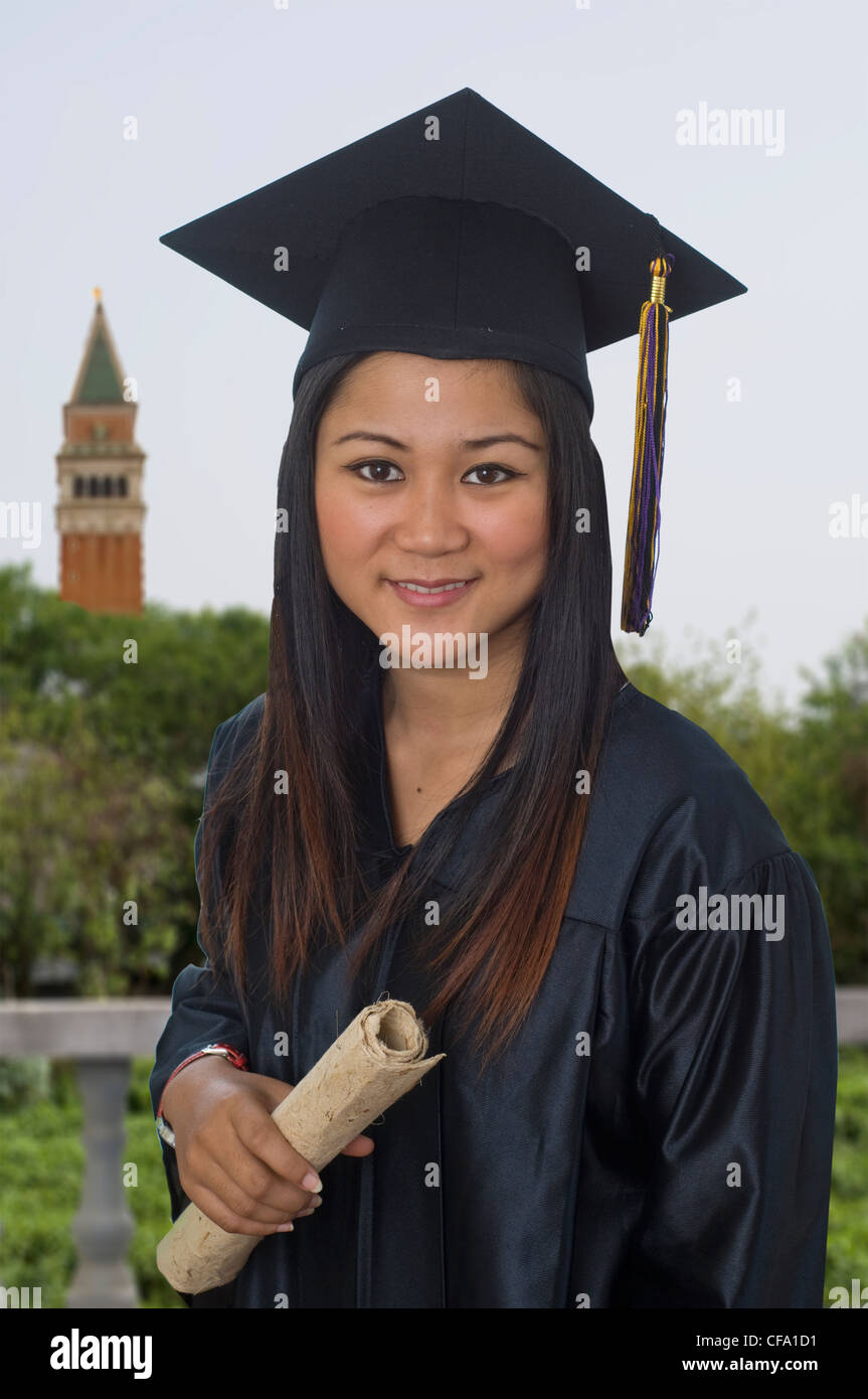 Young woman with graduation cap and gown holding diploma Stock Photo ...