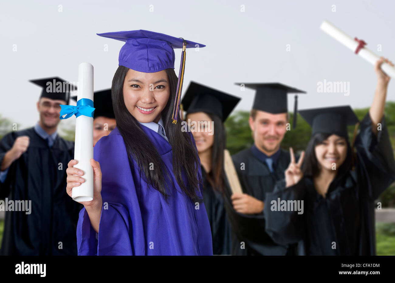 Young woman with graduation cap and gown Stock Photo - Alamy