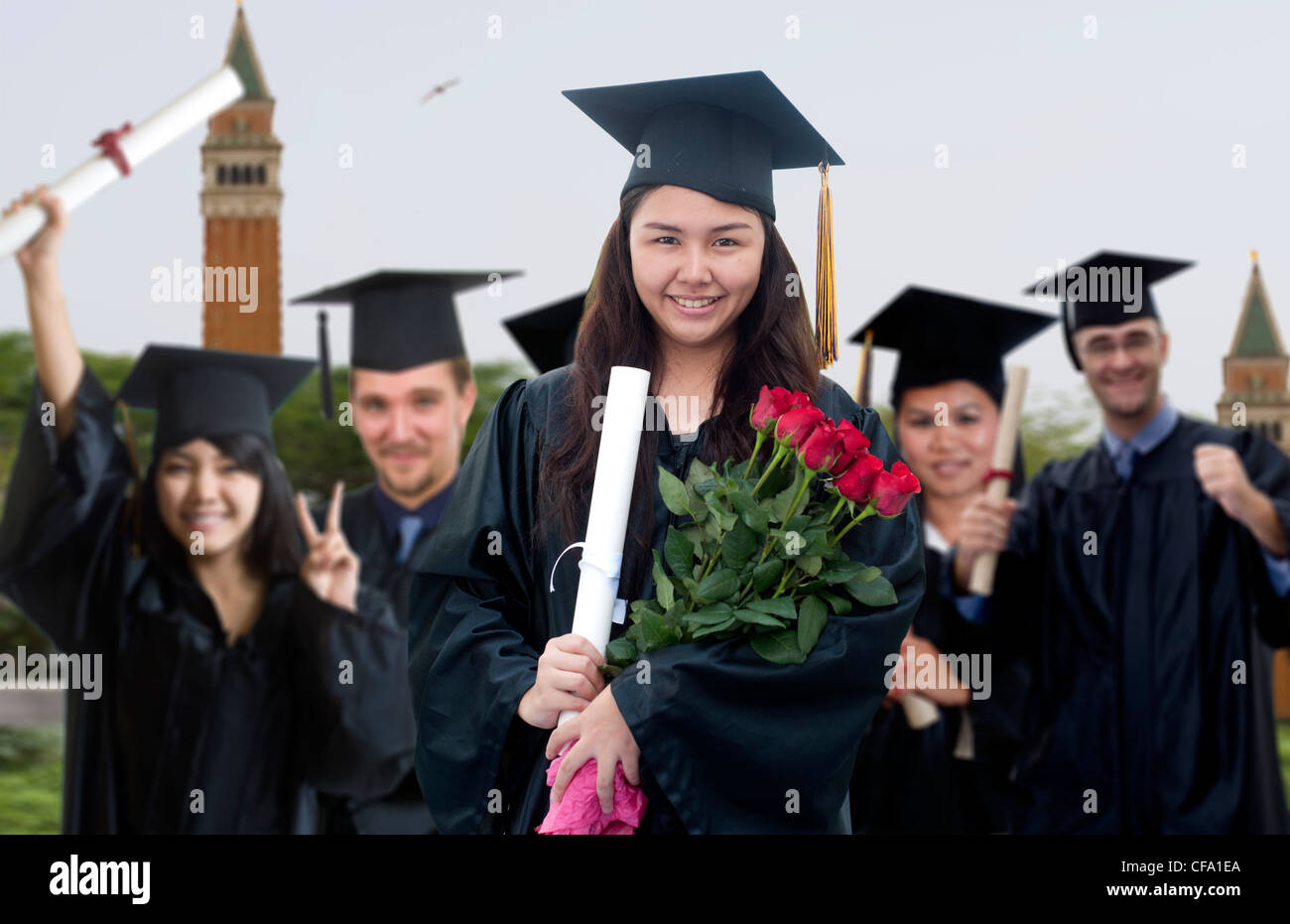 Young woman with graduation cap and gown holding roses Stock Photo - Alamy