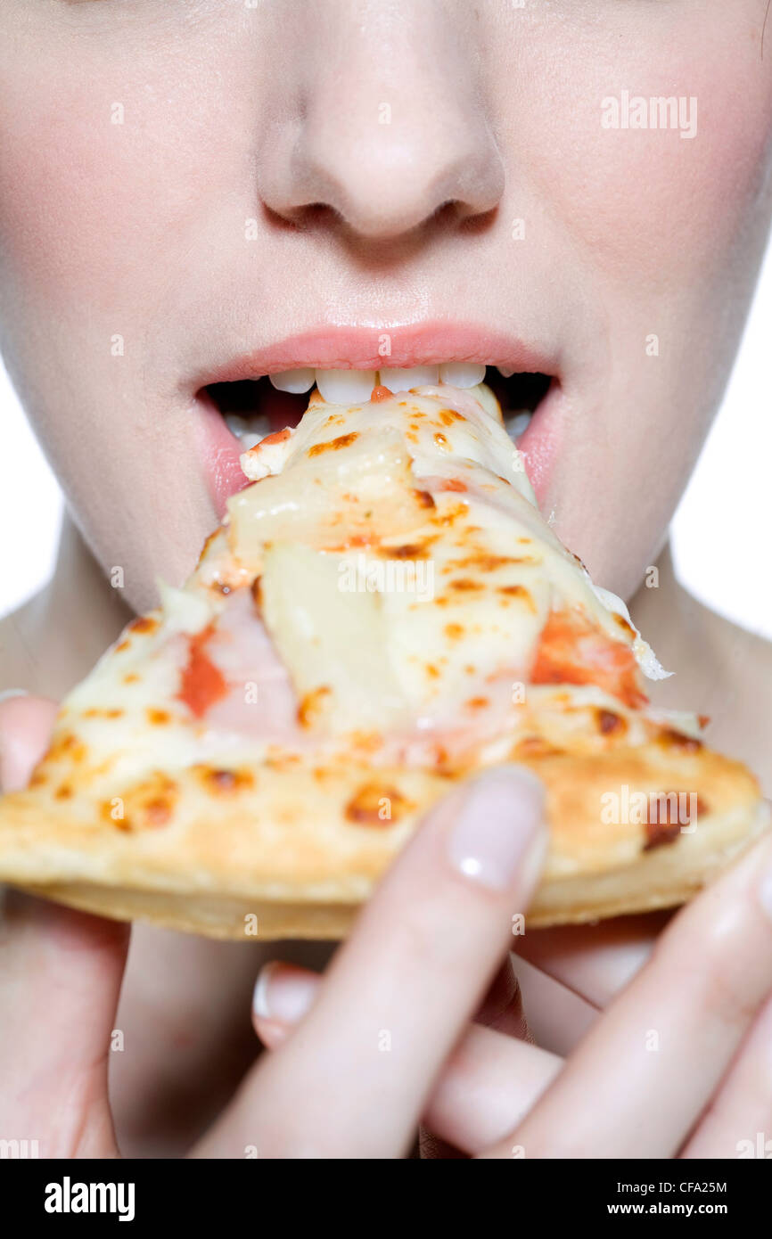 Female wearing pink lipgloss, eating a slice of pizza Stock Photo - Alamy