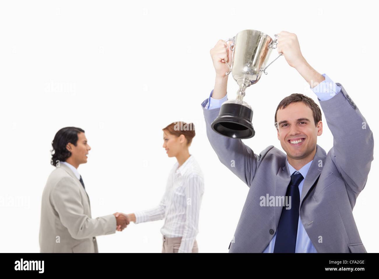 Businessman raising cup with hand shaking colleagues behind him Stock ...