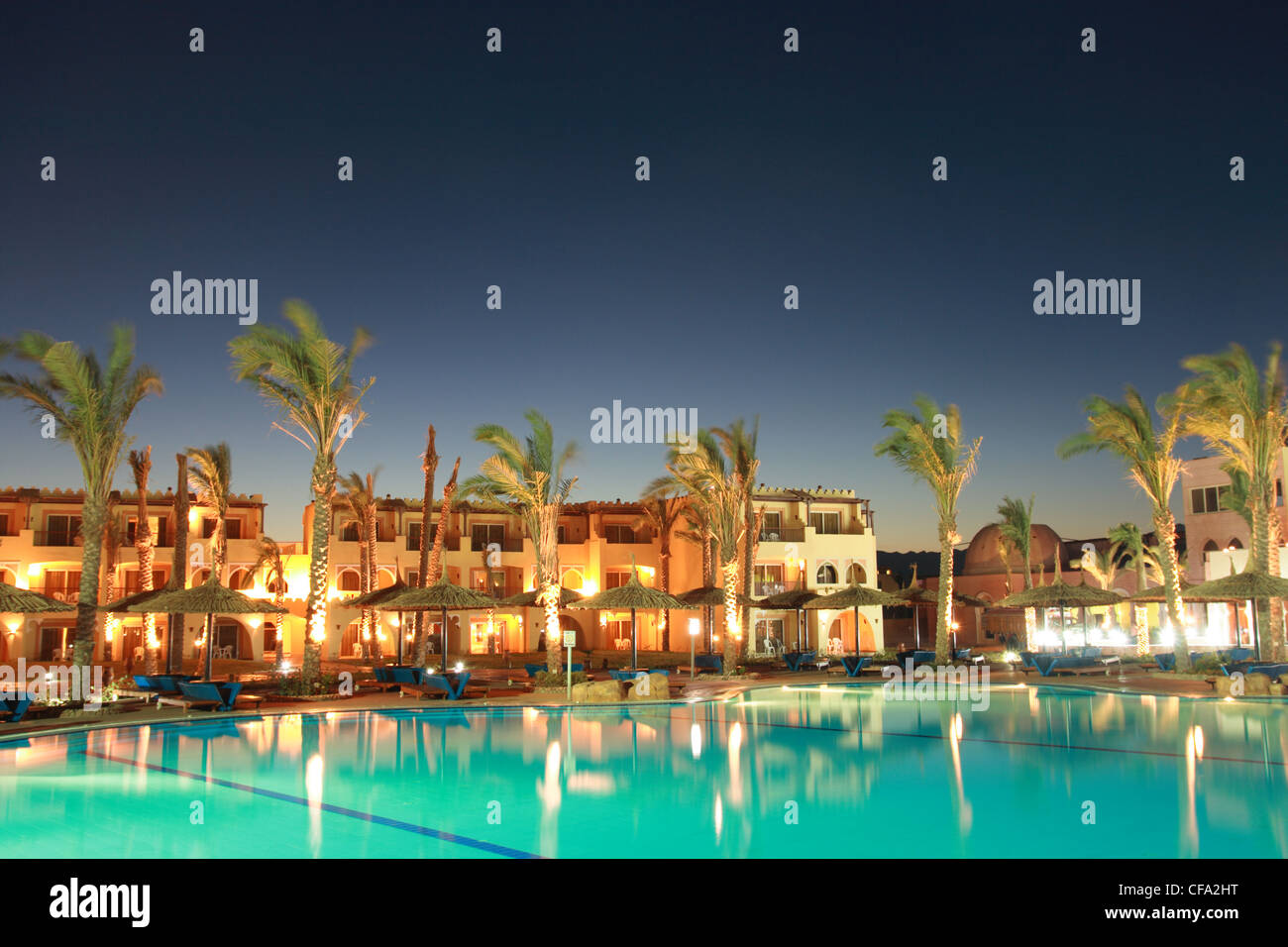 Recreational area in tropical hotel at night Stock Photo - Alamy