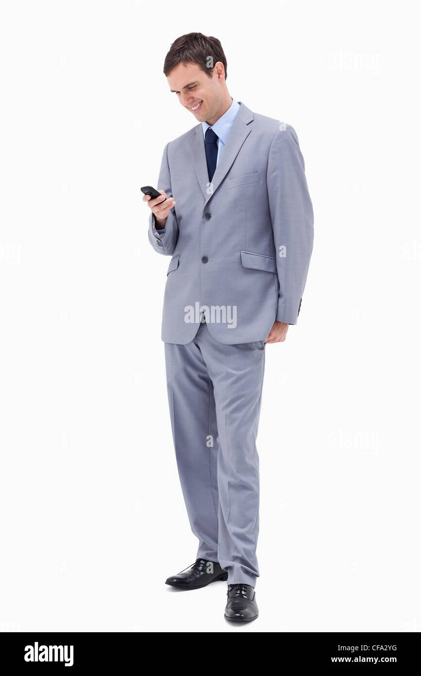 Smiling businessman reading text message Stock Photo - Alamy