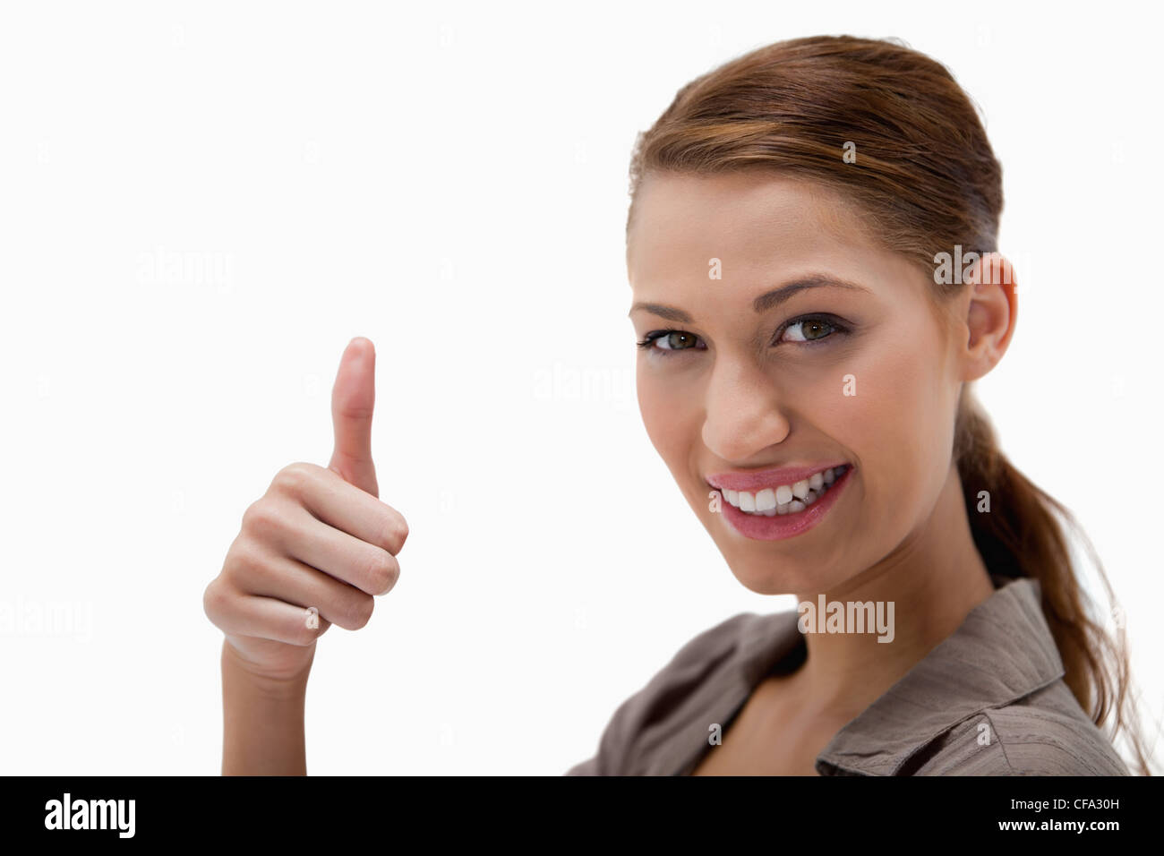 Side view of smiling woman giving thumb up Stock Photo - Alamy