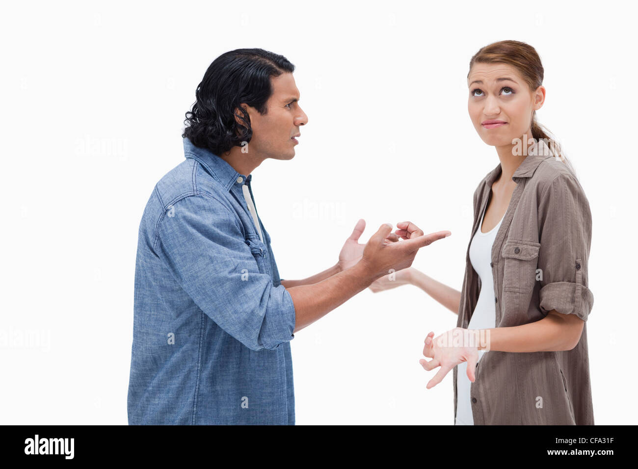 Side view of tensed talking couple Stock Photo - Alamy