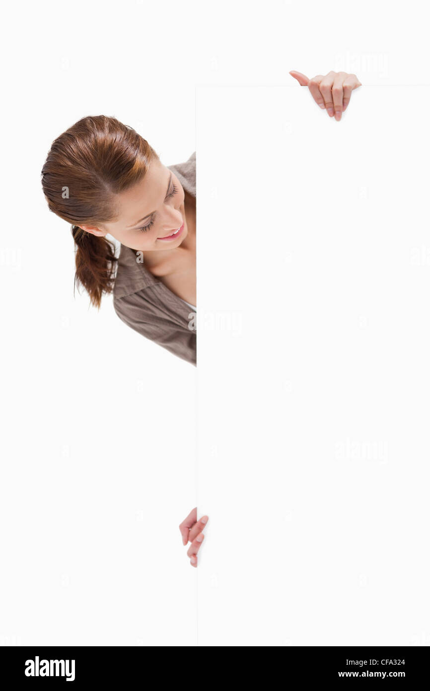 Woman looking at blank sign Stock Photo - Alamy