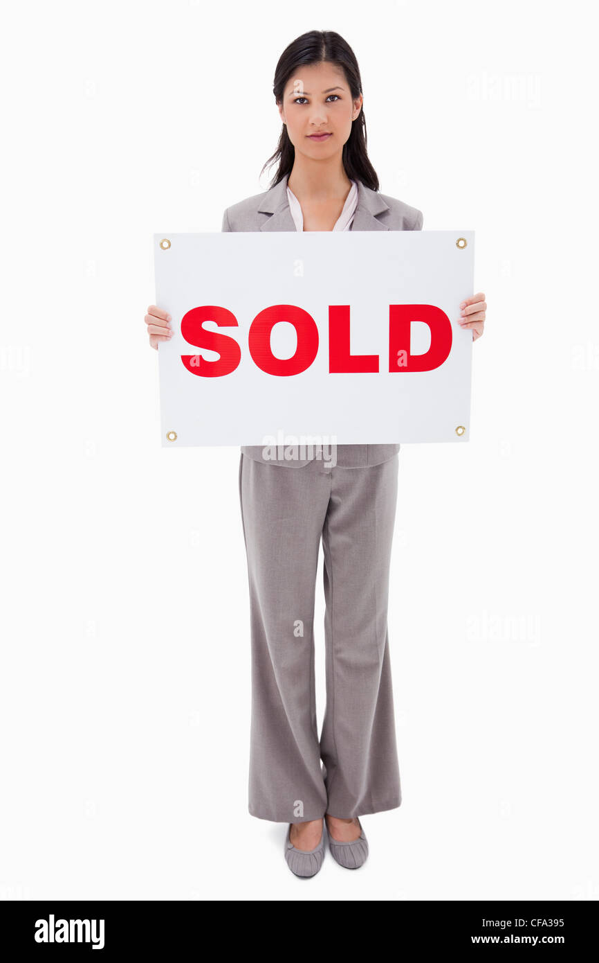 Real estate agent holding sold sign Stock Photo - Alamy