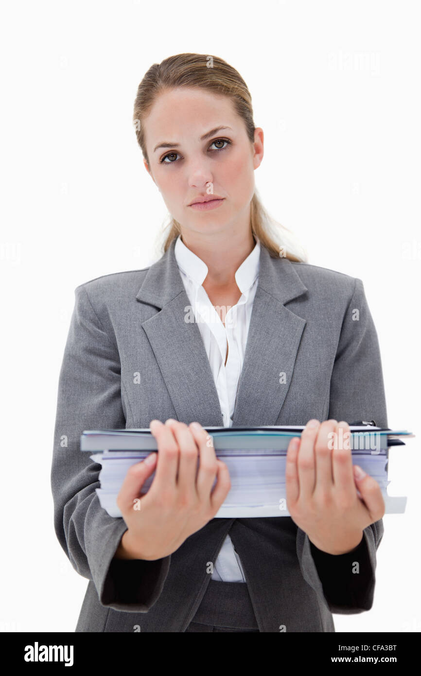Desperate office employee with pile of paperwork Stock Photo - Alamy