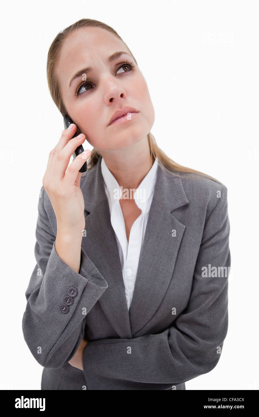 Sad bank employee on her cellphone Stock Photo - Alamy