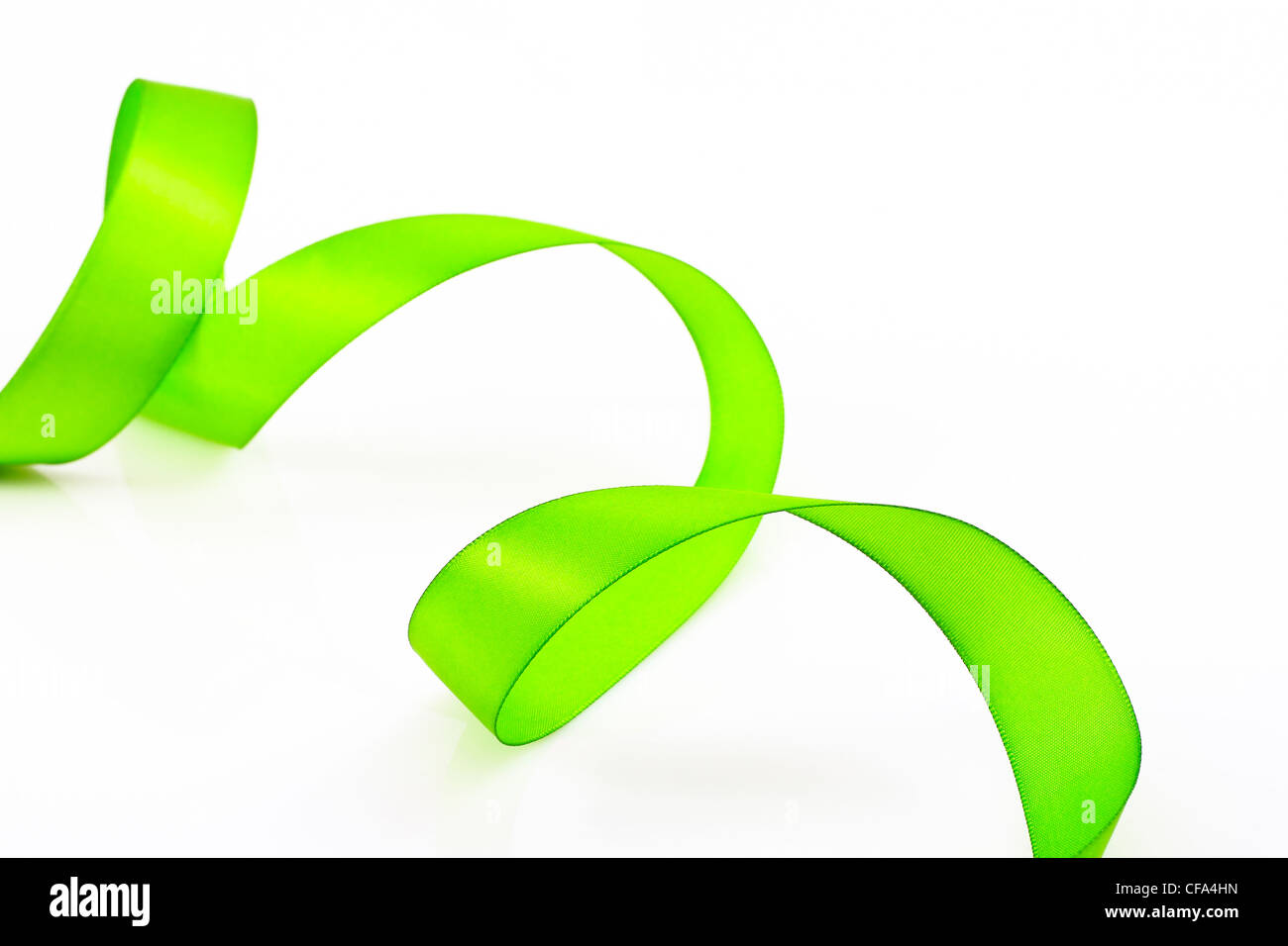 Spiraling lime green ribbon on white Stock Photo - Alamy