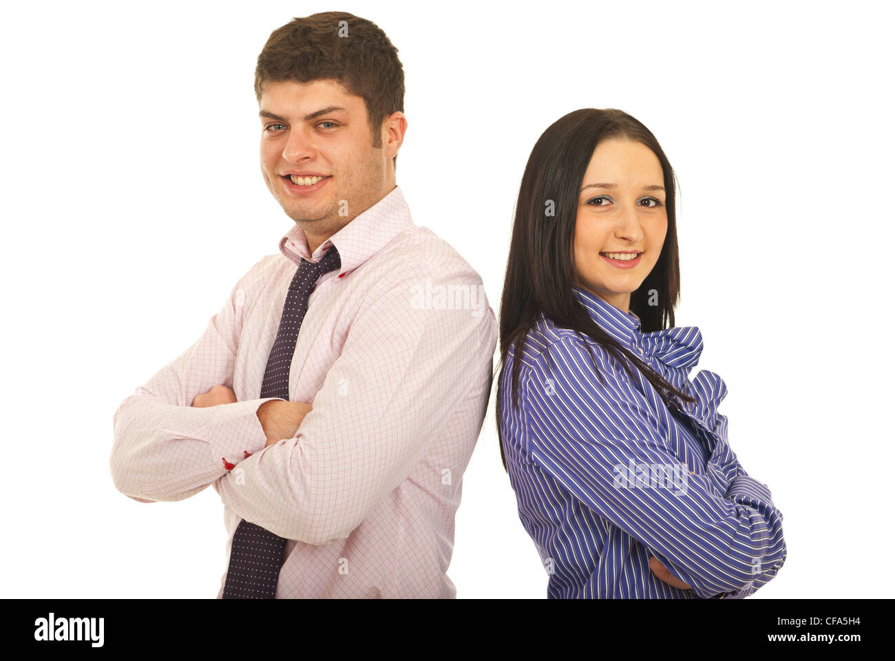 Cheerful business people standing back to back with arms folded ...