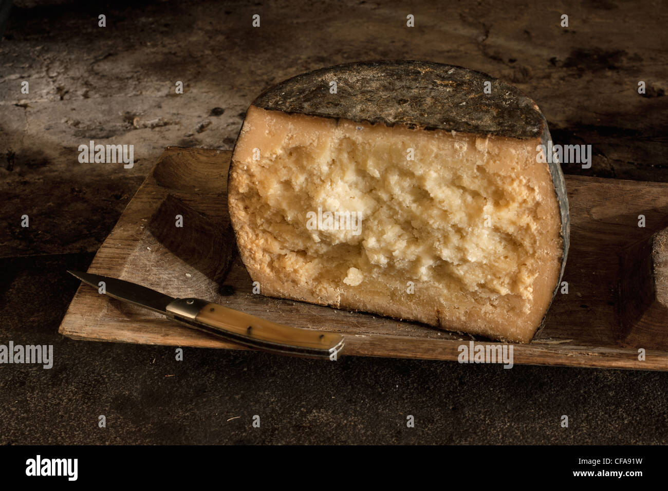 Close up of cut wheel of cheese Stock Photo - Alamy