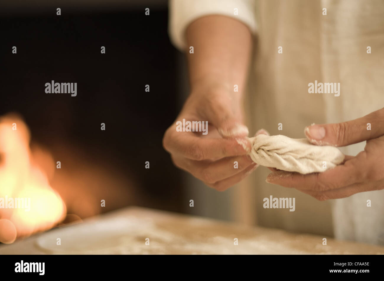 Cook folding filled pasta in kitchen Stock Photo - Alamy