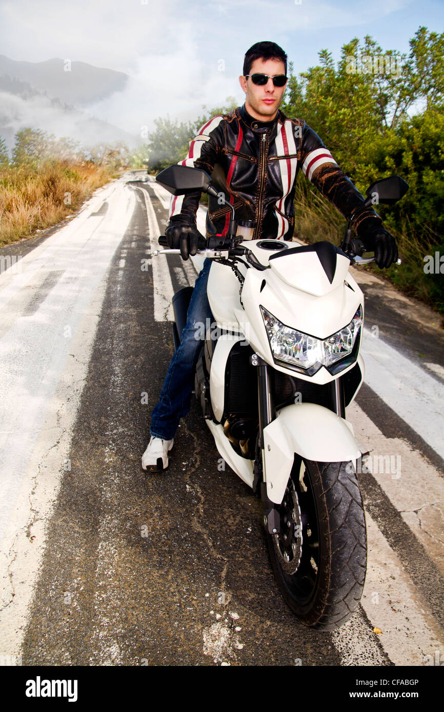 View of a man with a motorcycle on a asphalt road Stock Photo - Alamy