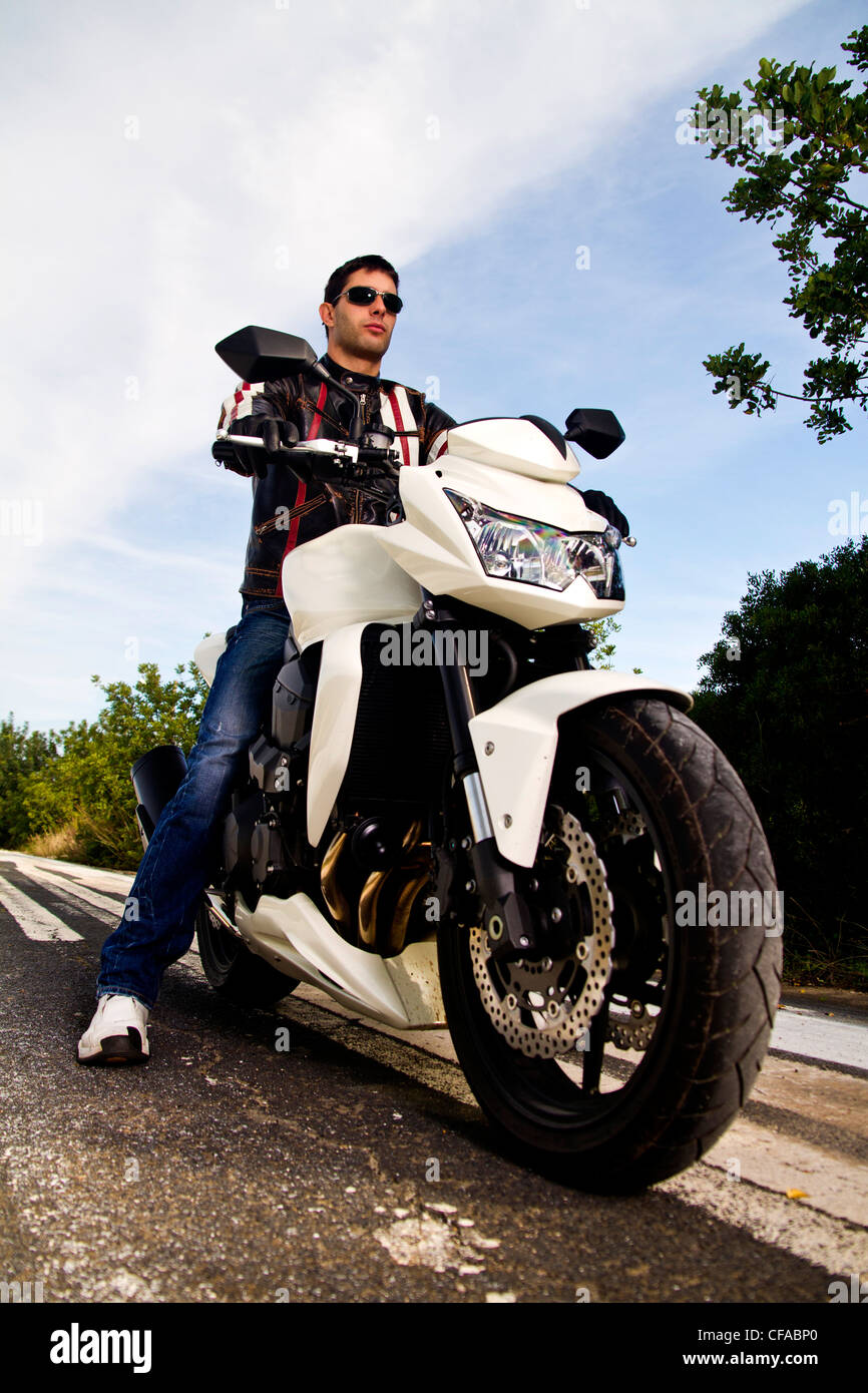 View of a man with a motorcycle on a asphalt road Stock Photo - Alamy